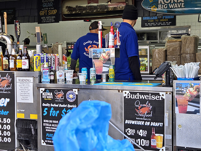 Blue-shirted maestros orchestrate the daily seafood symphony, keeping hungry customers happy one order at a time.