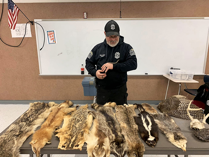 Park ranger sharing nature's secrets with fur samples &ndash; education that beats any classroom PowerPoint presentation.