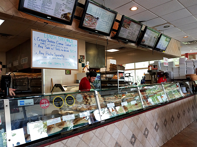 The pizza artisans at work. No fancy chef coats needed when your credentials are measured in perfectly crafted New York slices.