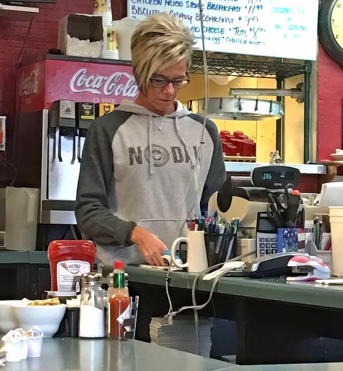 Friendly staff keeping everything running smoothly while wearing hoodies that say "NODAK"—breakfast served with genuine North Dakota warmth.