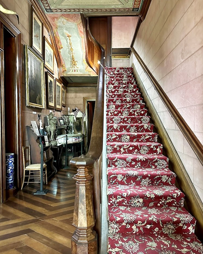 The crimson staircase carpet adds dramatic flair to every entrance. In Victorian times, this was the equivalent of a red-carpet Instagram moment.