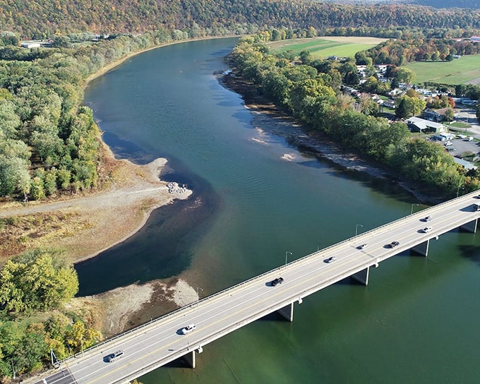 Fall foliage creates nature's confetti around the bridge crossing the Susquehanna—proof that Pennsylvania knows how to throw a seasonal color party.