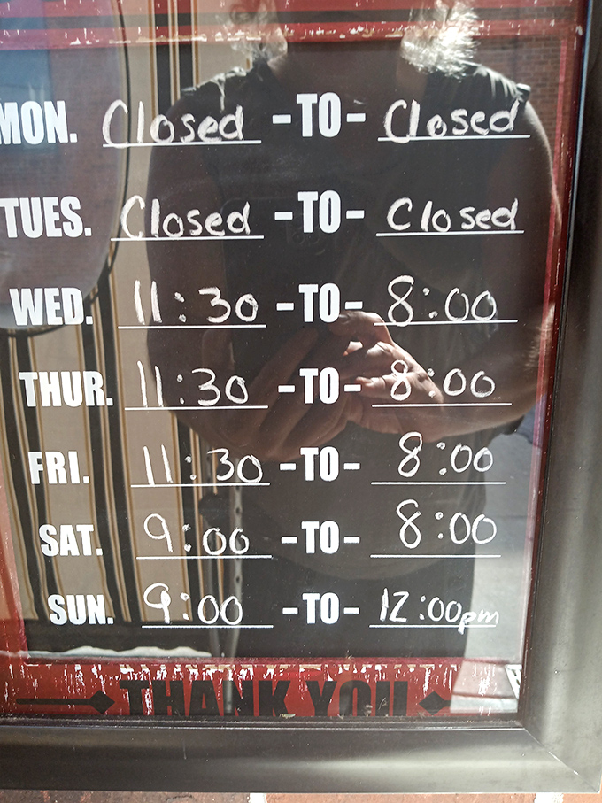 The handwritten hours on the door remind us that the best places march to their own schedule&mdash;closed Mondays and Tuesdays because even culinary legends need rest.