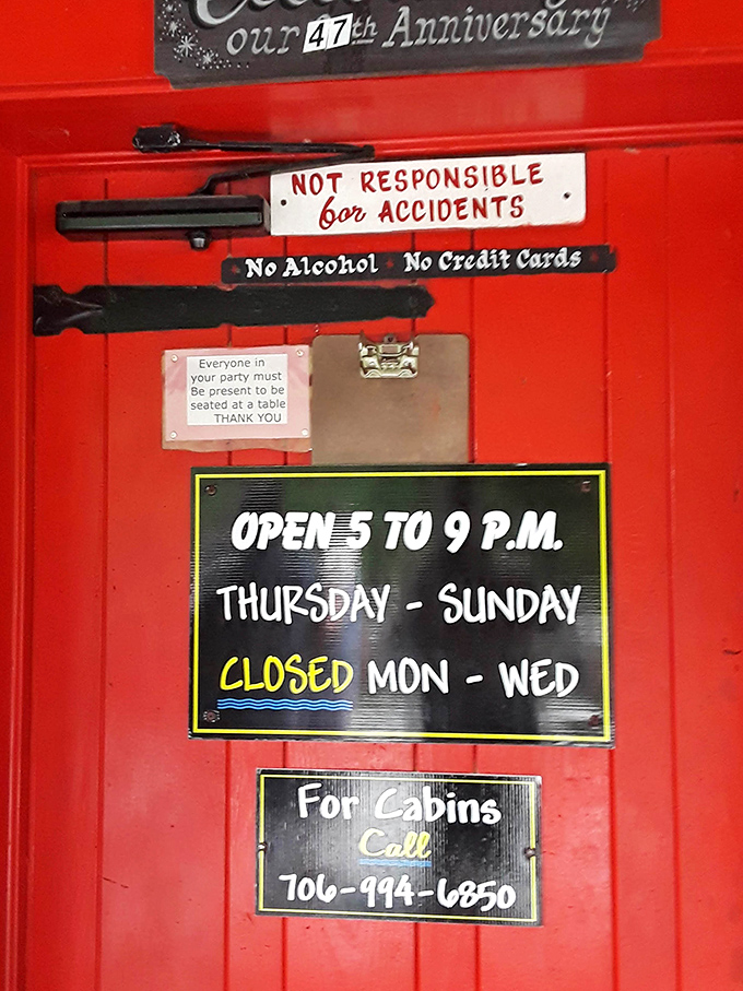 The door tells the whole story: Open Thursday through Sunday, cash or check only, and absolutely "Not Responsible for Accidents" caused by food comas.