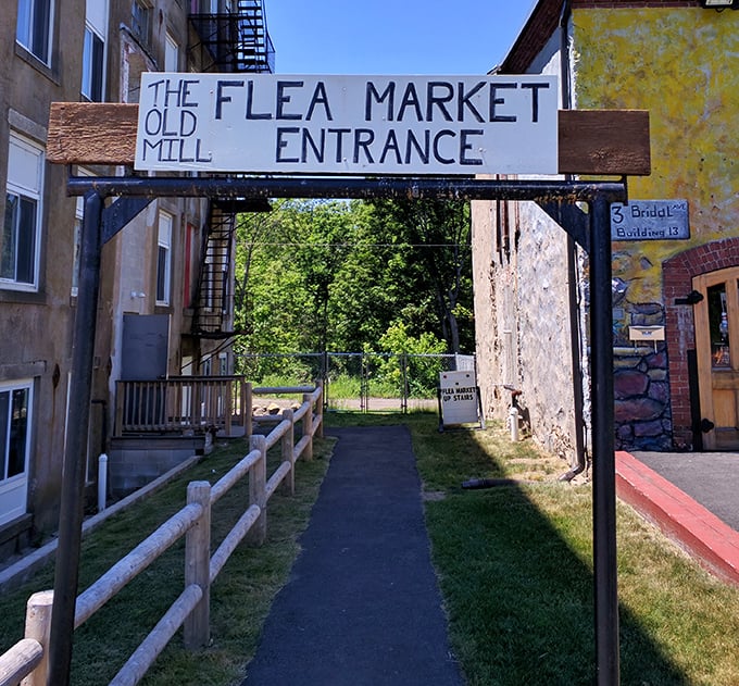 The Old Mill Flea Market entrance beckons treasure hunters and history buffs alike&mdash;where yesterday's discards become tomorrow's conversation pieces.