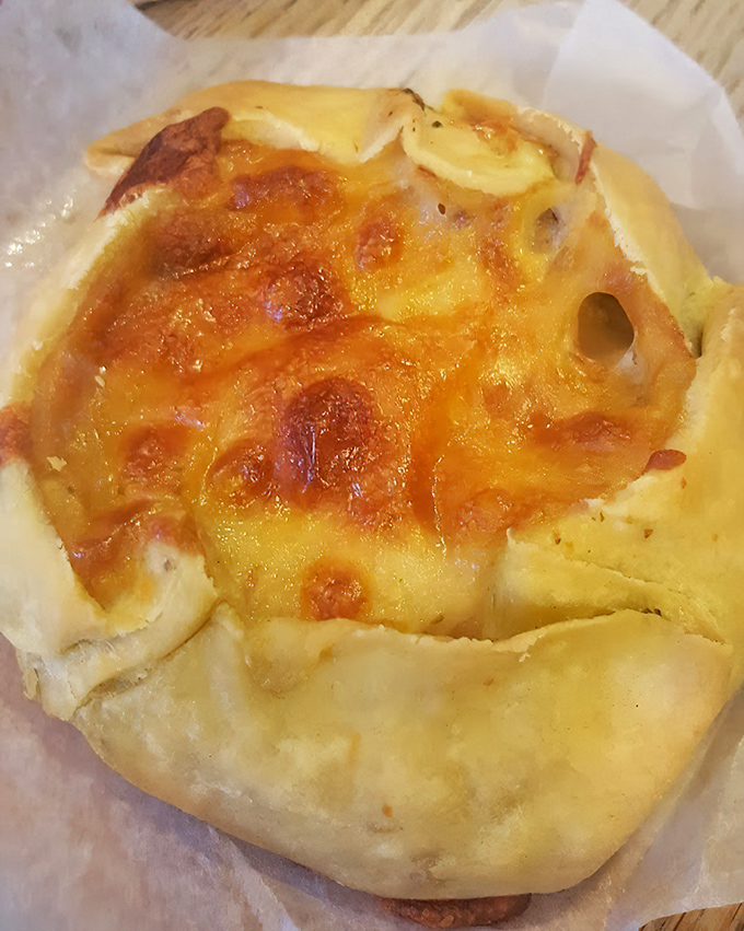 This savory pastry has achieved the golden-brown perfection that makes you want to applaud. Cheese bubbling like a standing ovation in edible form.