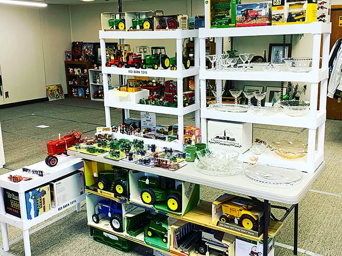 Farm toy heaven! John Deere tractors and crystal glassware sharing shelf space is the essence of flea market magic&mdash;unexpected combinations everywhere you look.