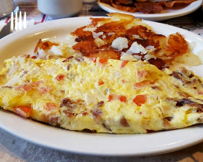This omelet has achieved the impossible—containing a garden's worth of vegetables while remaining impossibly fluffy. The homefries look on admiringly.
