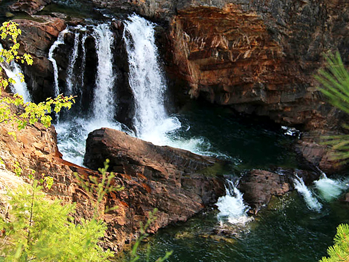 The layered rock walls tell geological stories spanning millions of years, while the falls provide the perfect soundtrack for their tales.