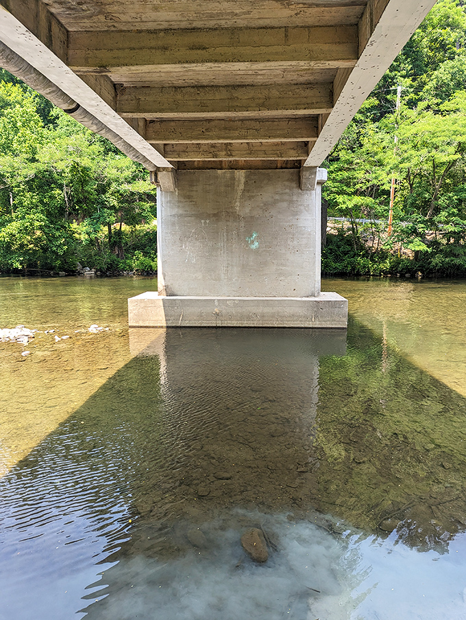 From below, the bridge's concrete supports create a striking contrast with the clear waters—form and function in perfect harmony.