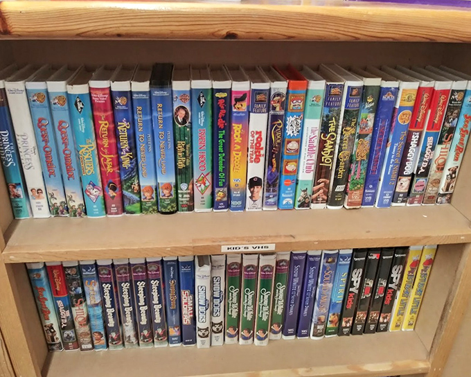 VHS tapes stand like ancient artifacts of entertainment history, Disney classics waiting to delight a new generation of tiny viewers.