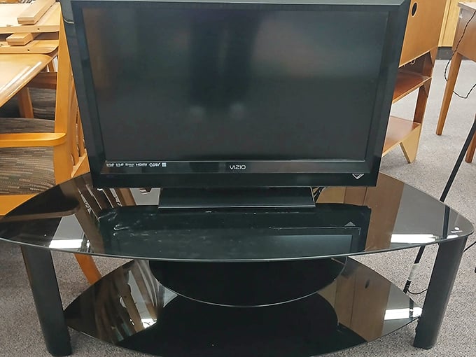 A flat-screen television with its glass stand, ready to anchor someone's entertainment center without emptying their entertainment budget entirely.