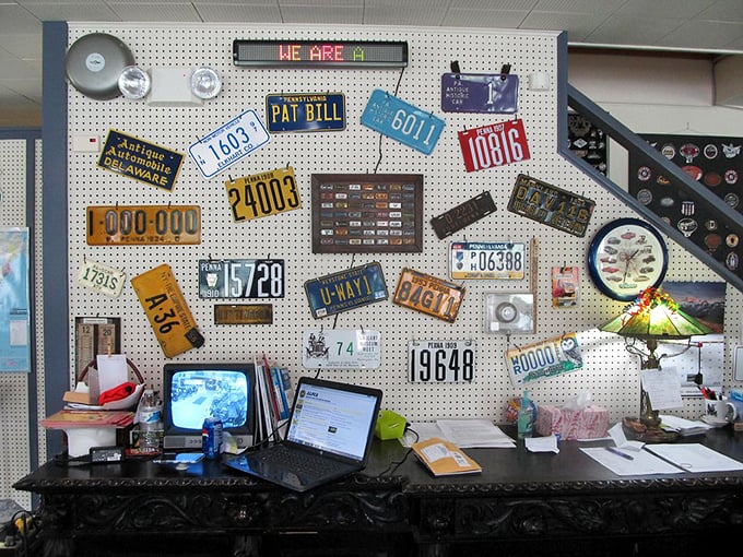 A colorful mosaic of vintage license plates creates a roadmap of American history, each plate a rectangular time capsule from highways long ago traveled.