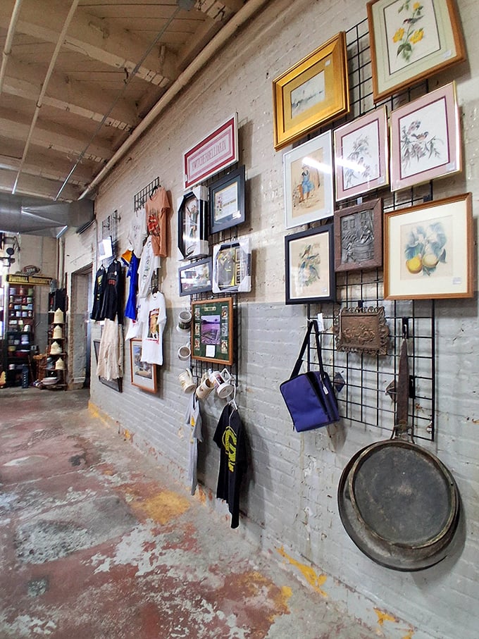 Gallery wall goals with vintage frames and forgotten artwork. That pan hanging on the end has definitely fried more eggs than your non-stick wonder.
