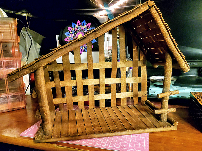 This handcrafted wooden nativity scene carries the fingerprints of its creator and awaits a new home to share its rustic charm.