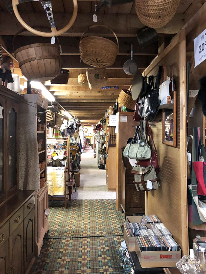 Baskets and handbags suspended from the ceiling create a textile canopy, while below, the treasure hunt continues down well-worn paths.