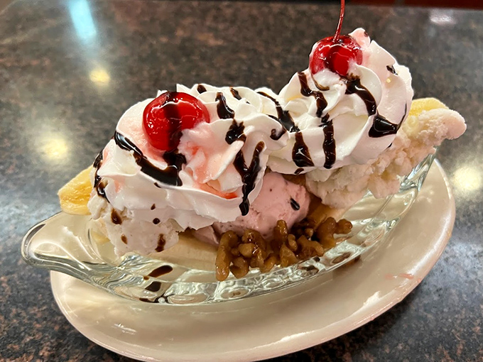 A banana split that laughs in the face of moderation. Whipped cream mountains, cherry-topped peaks, and chocolate rivers flowing into ice cream valleys.