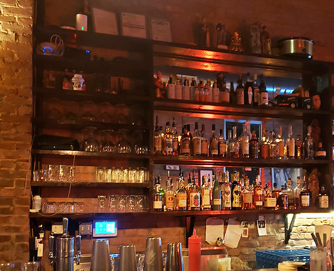 The bar shelves glow like an amber sunset, each bottle promising possibilities. This isn't just a drink selection; it's a carefully curated collection of liquid joy.