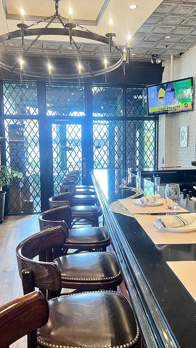 The bar area's diamond-paned windows filter light through the day, creating the perfect backdrop for your aperitivo moment.