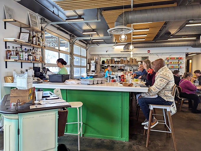 The mint-green bar area invites you to pull up a stool and watch breakfast magic happen. Coffee mugs here are never empty for long.