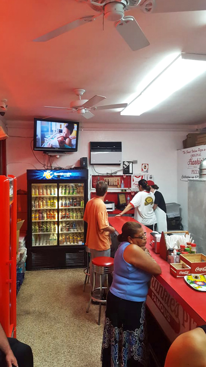 No fancy dining room needed&mdash;just ceiling fans, fluorescent lights, and the promise of pizza that makes everything else irrelevant.