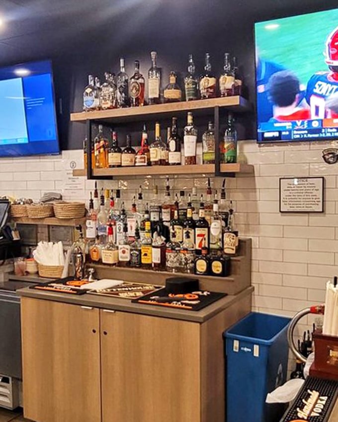The bar setup isn't just functional&mdash;it's a liquid library of possibilities that pairs perfectly with comfort food and sports on the screen. 