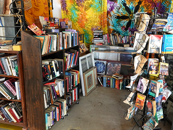Books stacked high beneath colorful tapestries create a bohemian reader's paradise with wallet-friendly prices throughout.