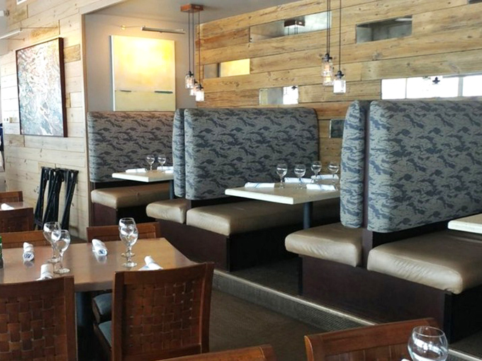 Booth seating with fish-patterned upholstery reminds you that yes, you're at the beach, and yes, you should definitely order seafood.