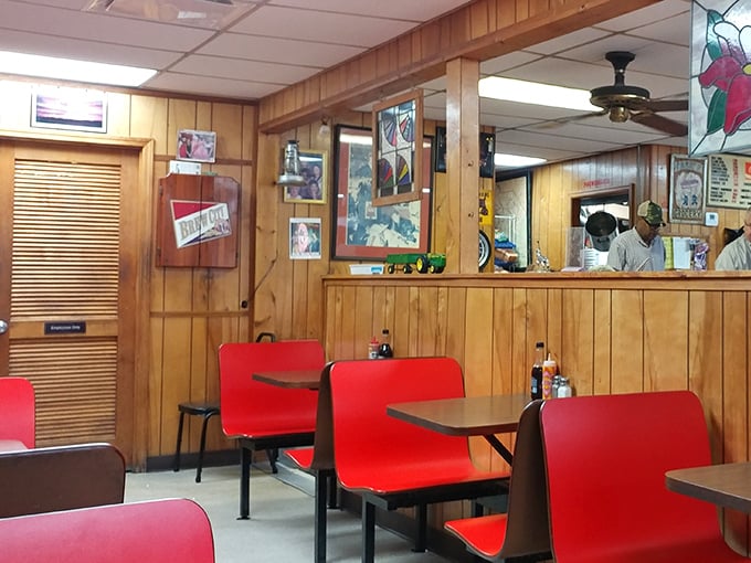 These red booth seats have cradled more local gossip, business deals, and family celebrations than any fancy restaurant in town.