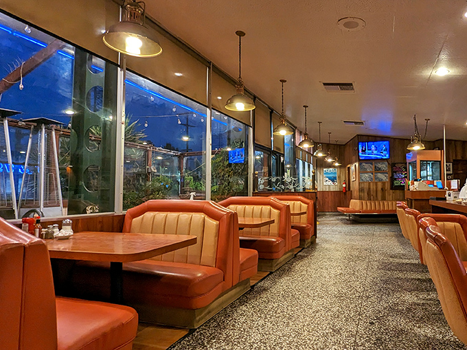 Evening light streams through windows, turning simple booths into cozy sanctuaries. Nighttime at Astro has its own special magic.