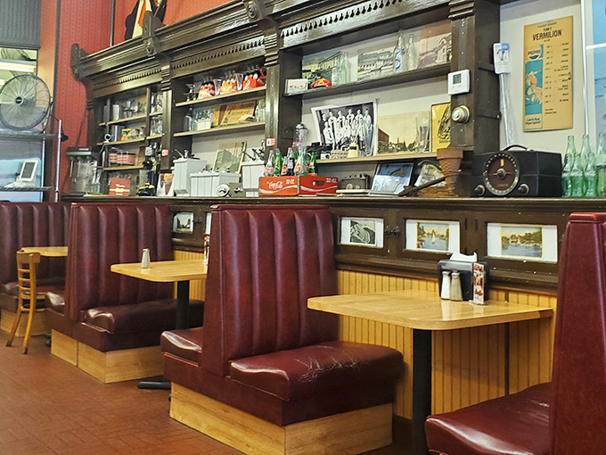 Those burgundy booths aren't just seating&mdash;they're front-row tickets to a bygone era where conversations happened face-to-face and phones stayed in pockets.