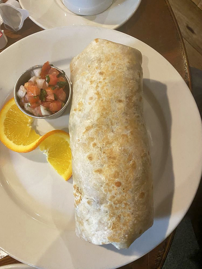 A breakfast burrito so perfectly wrapped it could teach a master class in food engineering, with fresh pico de gallo standing by for extra credit.