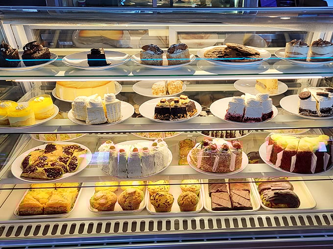 A dessert case that makes willpower crumble faster than their apple pie crust. Each shelf is a different chapter in the story of temptation.
