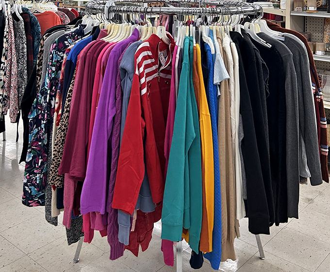 Clothes racks stretching like a rainbow of possibilities, where vintage meets modern at bargain basement prices.