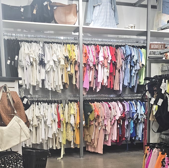 Color-coded clothing racks create a rainbow of possibilities. White blouses transition to yellows, pinks, and blues like a fashionable sunset.