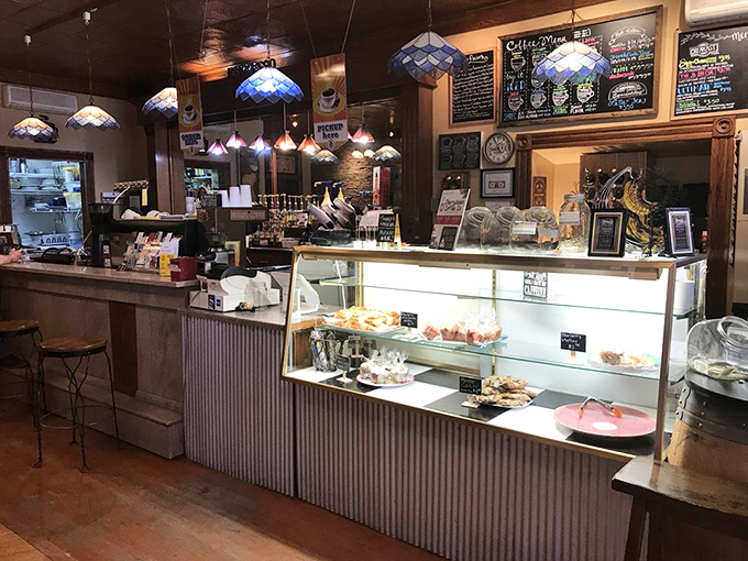 The display case: where good intentions about "just having coffee" go to die a delicious, pastry-filled death.