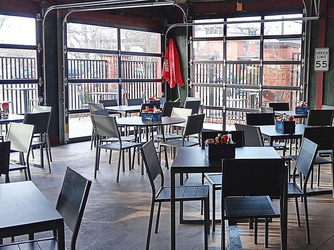 The covered patio extends your dining options into fresh air, proving that even former jails deserve outdoor living space and umbrella shade.