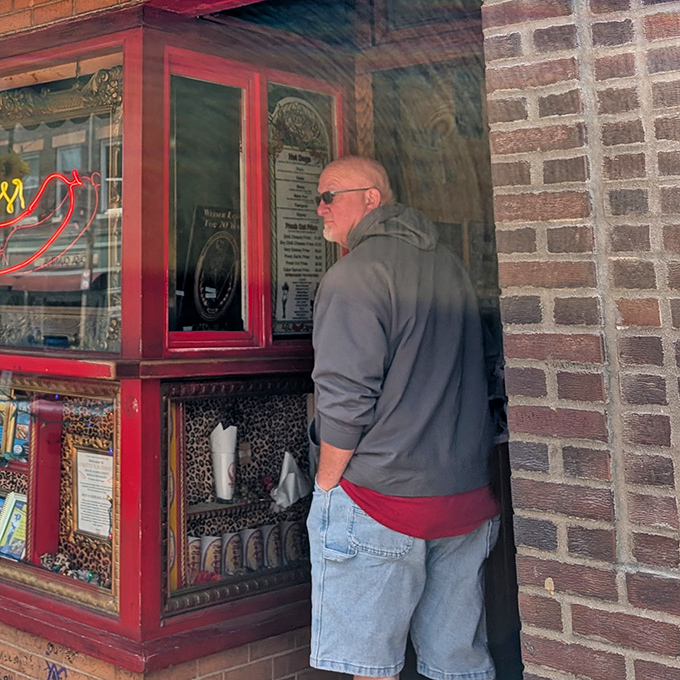 The anticipation is half the pleasure. This customer knows he's moments away from hot dog nirvana as he places his order.