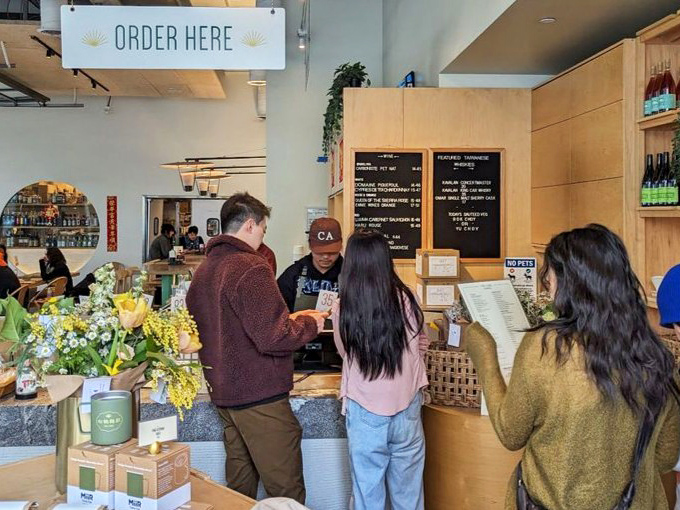 Customers line up eagerly, surrounded by fresh flowers and the promise of Taiwanese culinary treasures ahead.