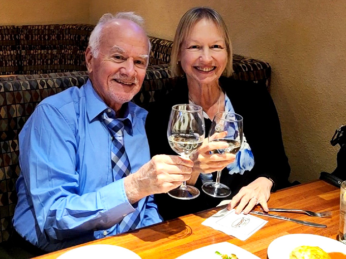 The universal language of "cheers" being spoken by happy diners raising glasses to good food, good company, and the joy of not doing dishes.