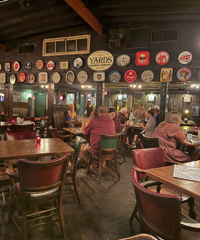 Beer signs create a gallery wall of hoppy history above diners lost in conversation and comfort food. Norman Rockwell meets craft brewing.