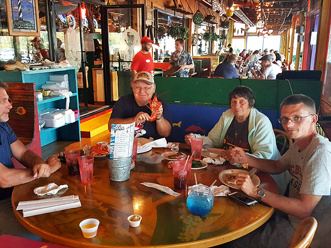 Nothing says "we made the right restaurant choice" like the triumphant display of a crab leg held aloft by a satisfied diner.