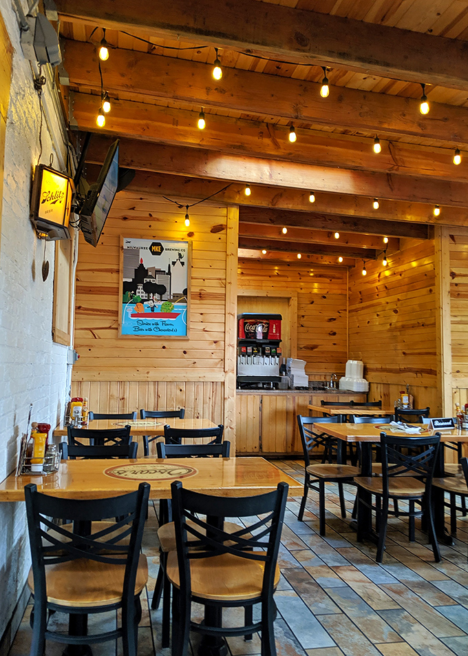 String lights cast a warm glow over wooden walls, creating the kind of atmosphere where food tastes better and conversations flow easier.