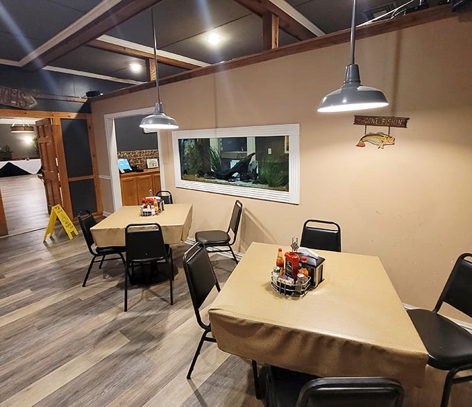 Modern gray tones meet rustic wood paneling in a dining room that feels both updated and authentically Louisiana simultaneously.