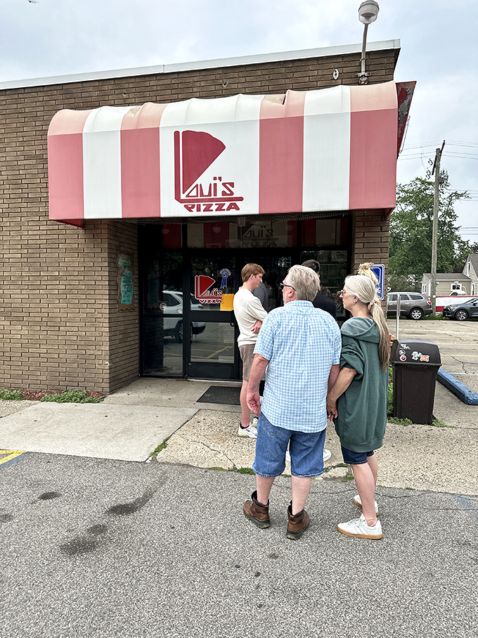 The entrance to Loui's often features a line of patient pizza pilgrims, willing to wait for their rectangular slice of heaven.
