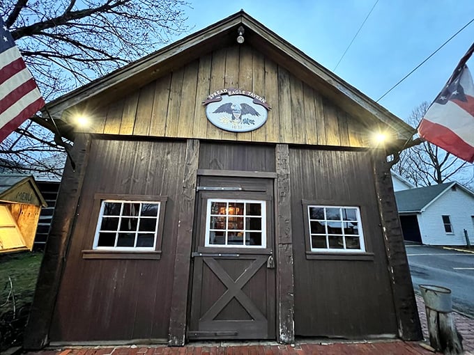 Evening lights illuminate the entrance, beckoning travelers just as this tavern has done for generations of weary souls.