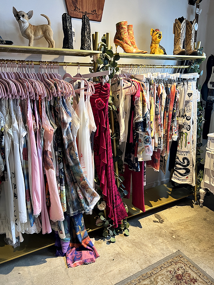 Vintage dresses and boots that whisper tales of decades past. That chihuahua figurine stands guard over fashion treasures waiting for their second life.