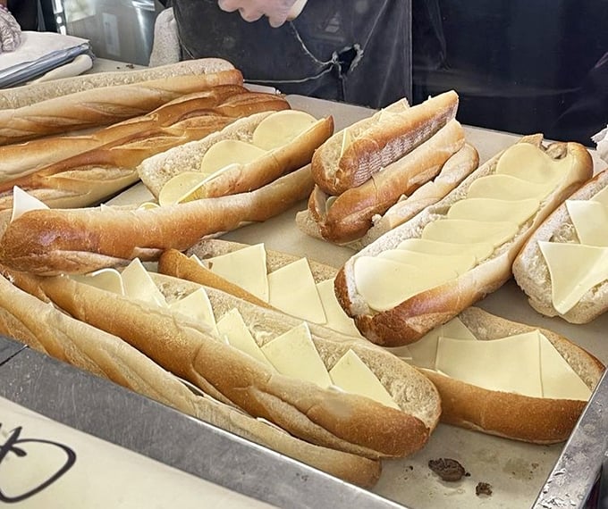 Fresh rolls await their destiny, already layered with cheese&mdash;the foundation of greatness being built before your eyes.