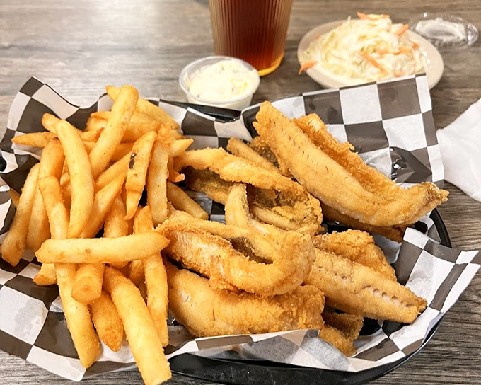 This fried fish basket isn't just food; it's Friday tradition served in checkered paper with a side of nostalgia.