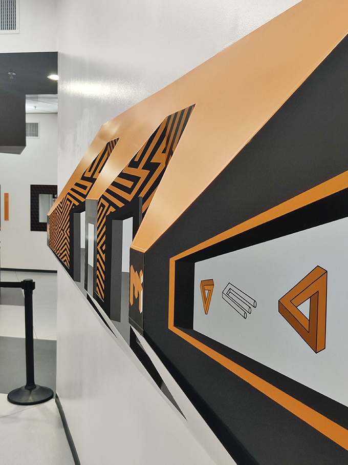 Impossible triangles and mind-bending geometric patterns line the walls, creating a hallway that would make M.C. Escher drop his pencil in admiration.